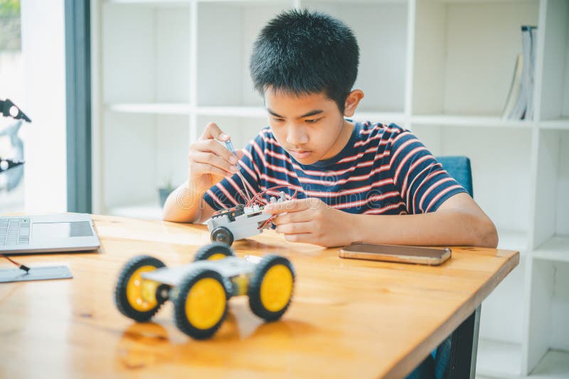 Asian Male Science Students Looking through a Microscope and Tests of ...
