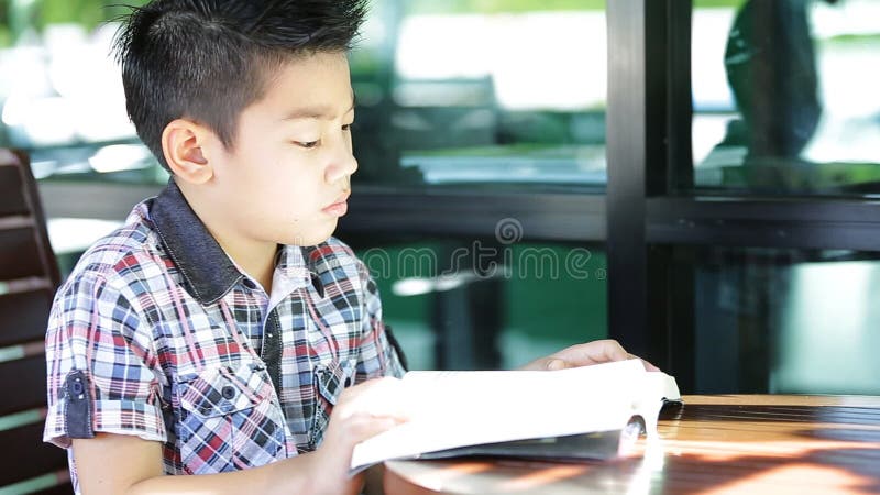 Asian Boy Reading Book in Library Stock Photo - Image of childhood ...