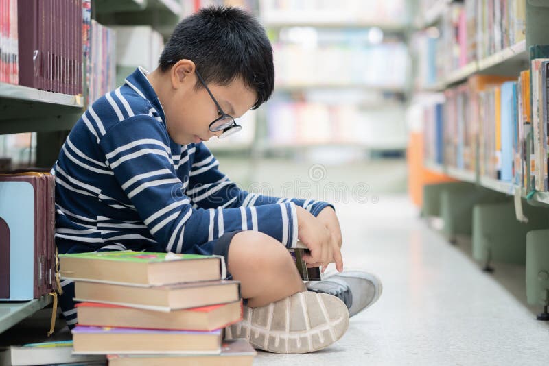 Asian Boy Reading a Book in the Library Stock Photo - Image of learn ...