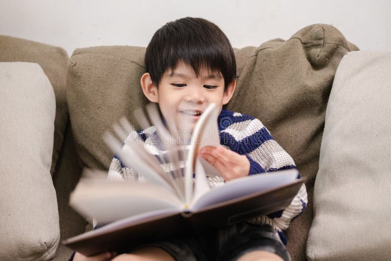 Asian Boy Reading a Book on the Sofa Learning Outside the Classroom ...
