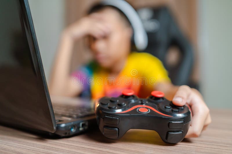 Asian Boy Sitting with His Eyes Closed while Playing Computer Games ...