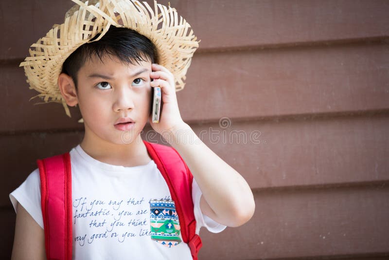 Asian boy speaks by phone stock photo. Image of people - 53114416