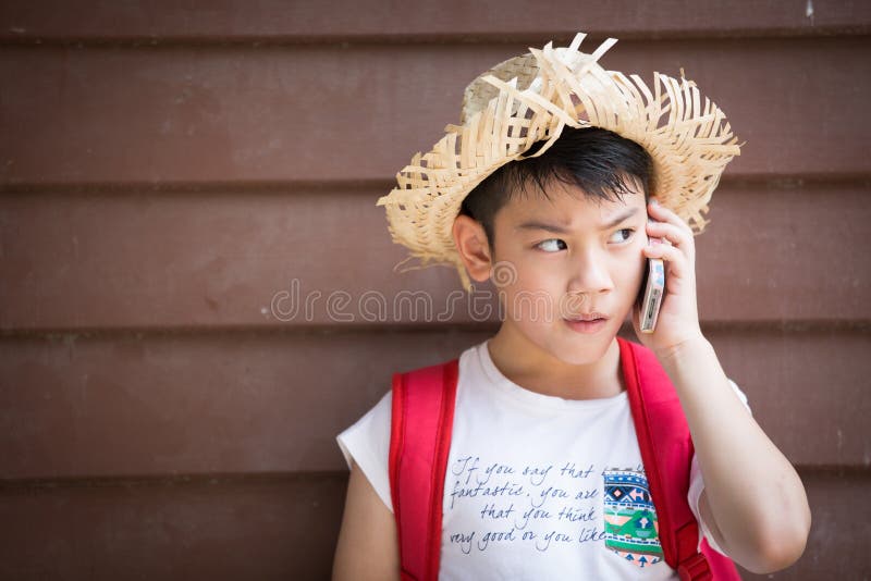 Asian boy speaks by phone stock photo. Image of people - 53114416
