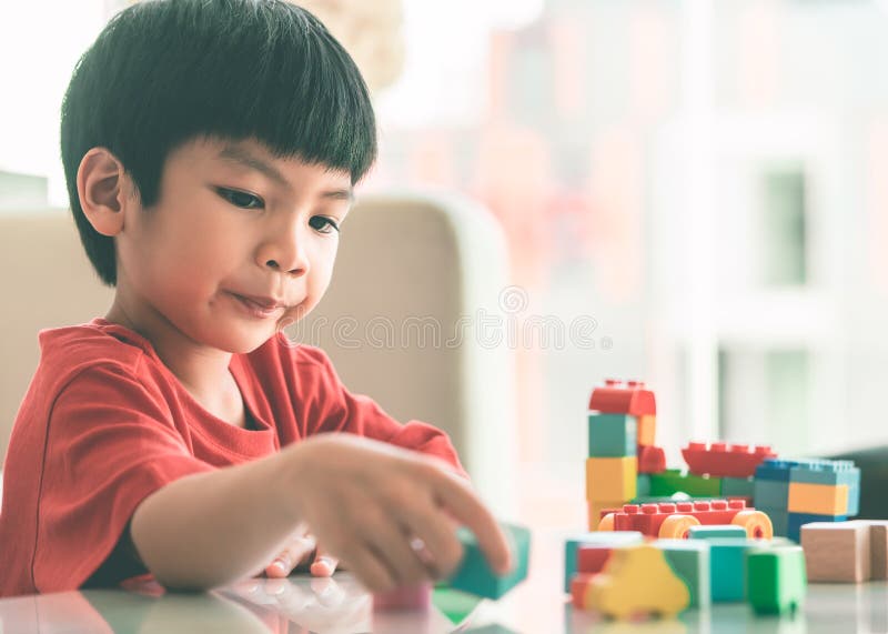 Boy Stacking Toy Blocks on a Living Room Table for Children Play and ...