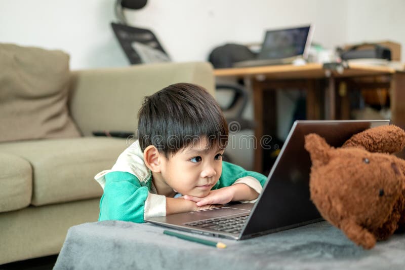 Asian Boy Studying Online and Doing Activities on Laptop Stock Image ...