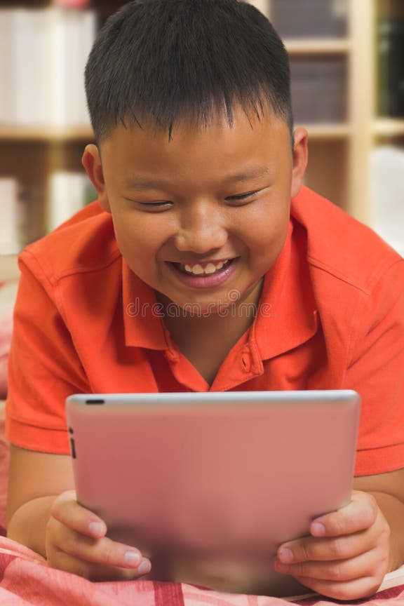 Asian Boy with a Tablet Computer Stock Image - Image of cheerful ...