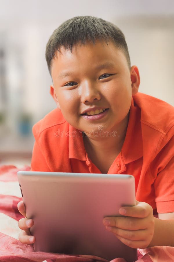 Asian Boy with a Tablet Computer Stock Image - Image of cheerful ...