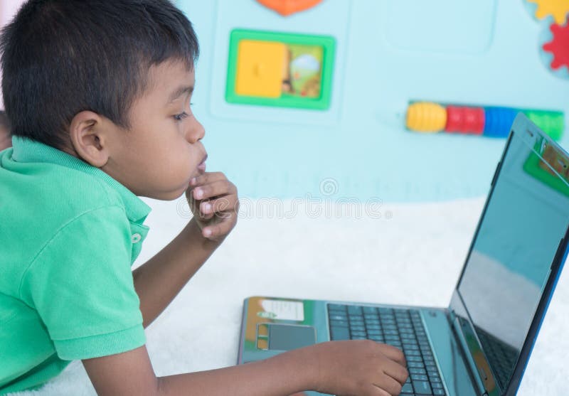 Asian boy useing computer stock photo. Image of learning - 133831922