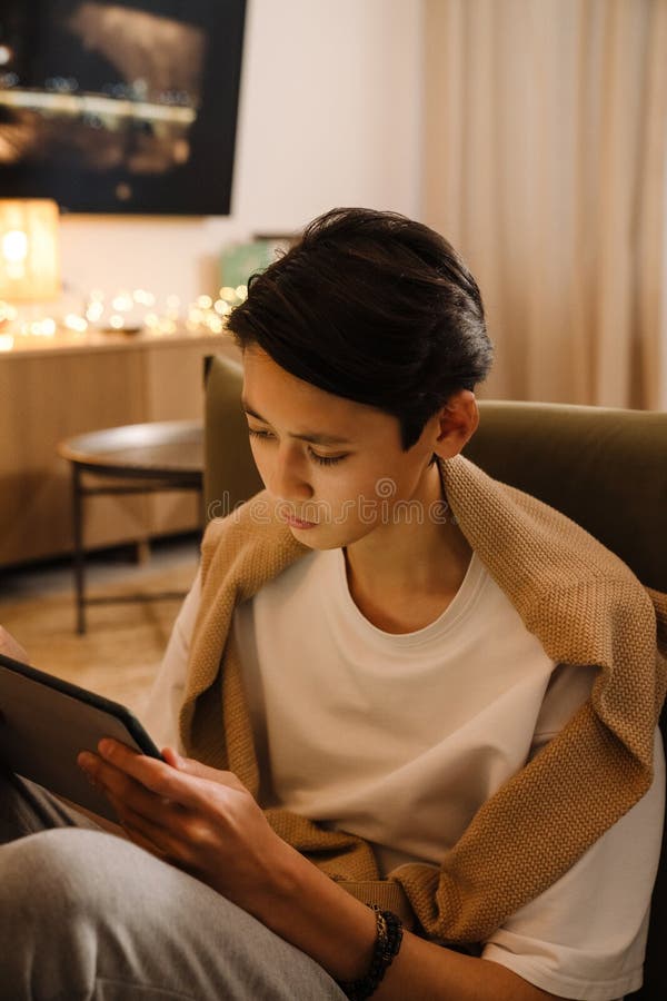 Asian Boy Using Tablet Computer while Sitting on Floor Stock Photo ...