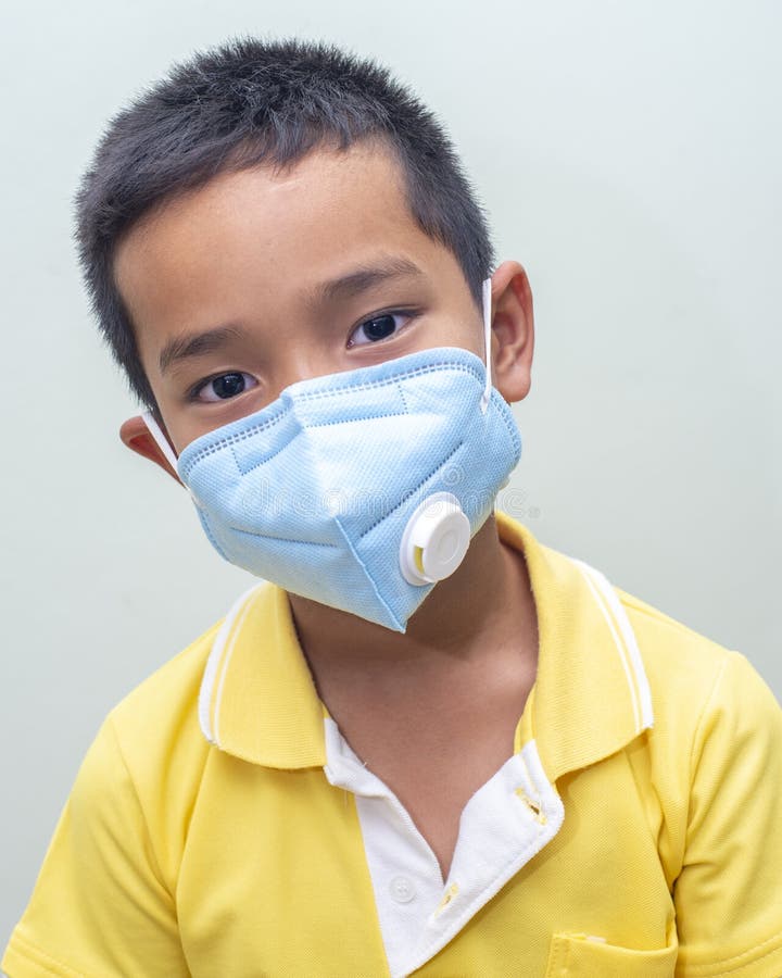 Asian Boy Wears a Protective Mask. COVID-19 Stock Image - Image of ...