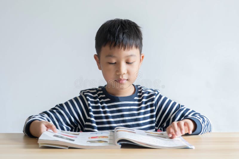 Asian Boy Who are Studying in Elementary School Reading and Doing ...