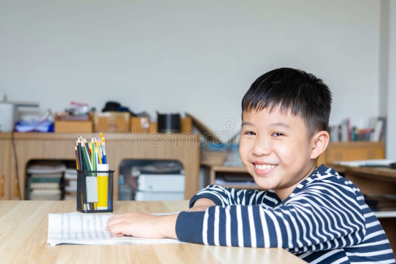 Asian Boy Who are Studying in Elementary School Reading and Doing ...