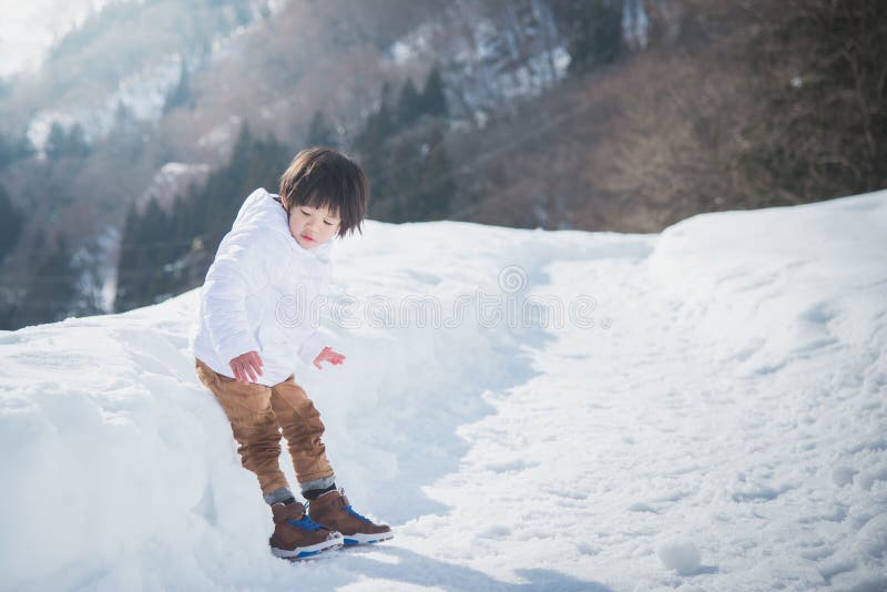Asian Boy in Winter Clothes with Snow Background Stock Photo - Image of ...