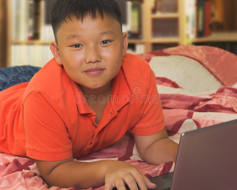 Asian Boy Working on a Laptop Computer Stock Photo - Image of bedroom ...