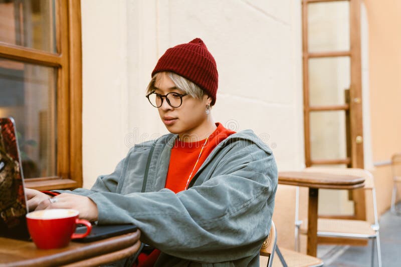 Asian Boy Working with Laptop while Drinking Coffee in Cafe Stock Photo ...