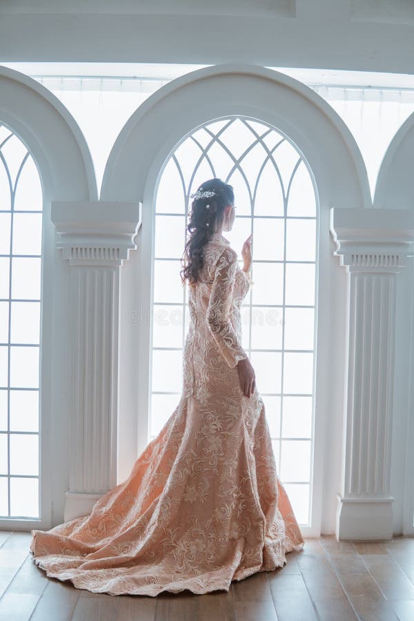 Asian Bride Standing and Looking Outside from the Window Stock Image ...
