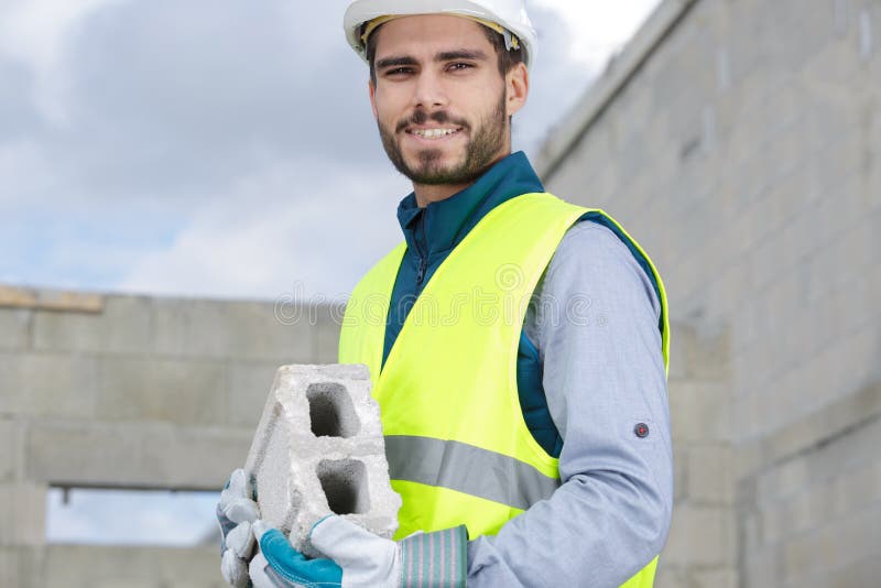 Asian Builder Man Holding Concrete Blocks for House Building Stock ...