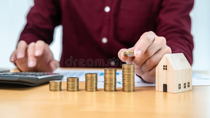 Asian Business Man Putting Coin Increase on Coins Stacking with House ...