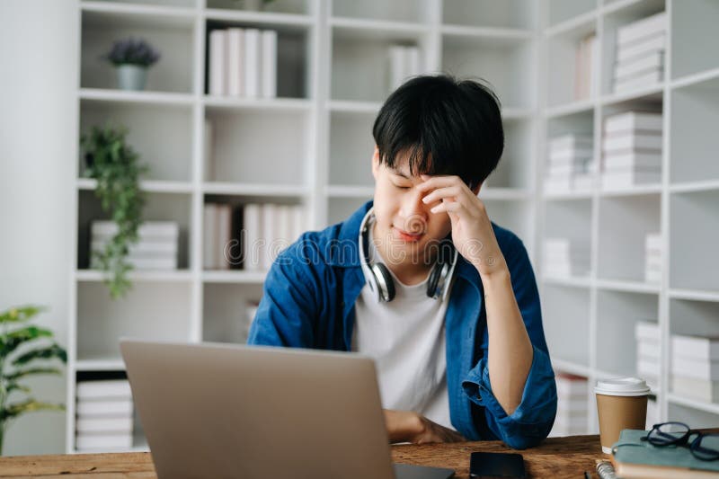 Asian Business Man is Stressed, Bored, and Overthinking from Working on ...