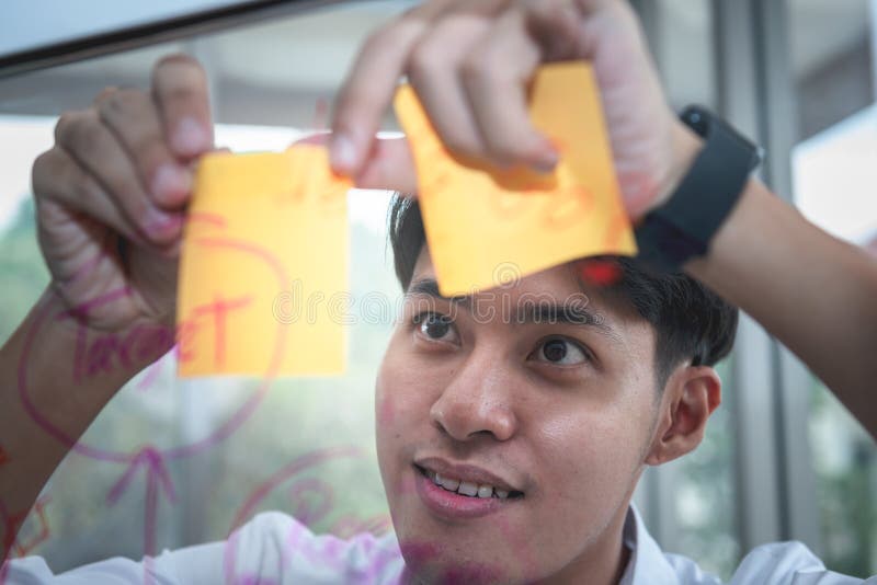 Asian Business Man is Using a Handle To Note the Text Sheet Which is ...