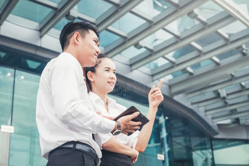 Asian Business People Meeting and Using Digital Tablet Outdoor a Stock ...