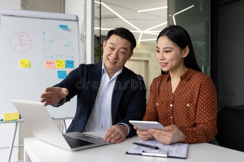 Asian Business Team Collaborating in Modern Office Environment with ...