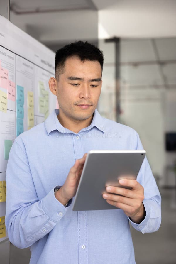Asian Business Project Leader Man Using Internet Technology on Tablet ...