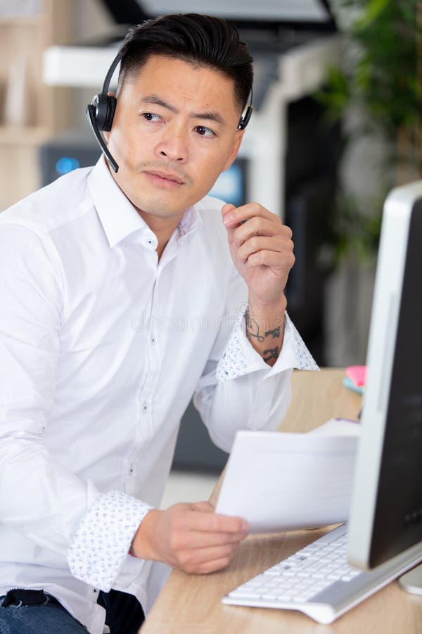 Asian Businessman at Computer Desk Wearing Headset Stock Photo - Image ...
