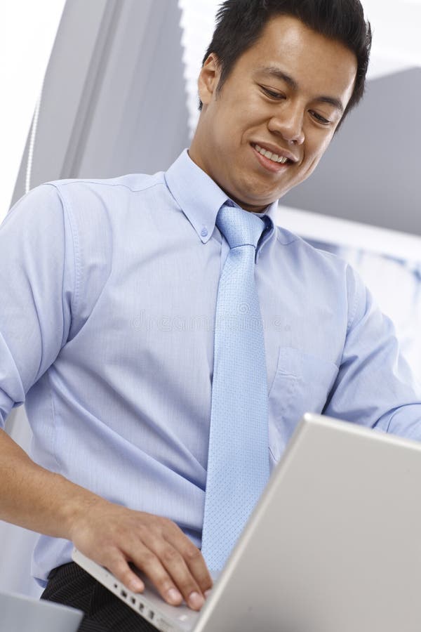 Asian Businessman Using Laptop Stock Photo - Image of seated, oriental ...