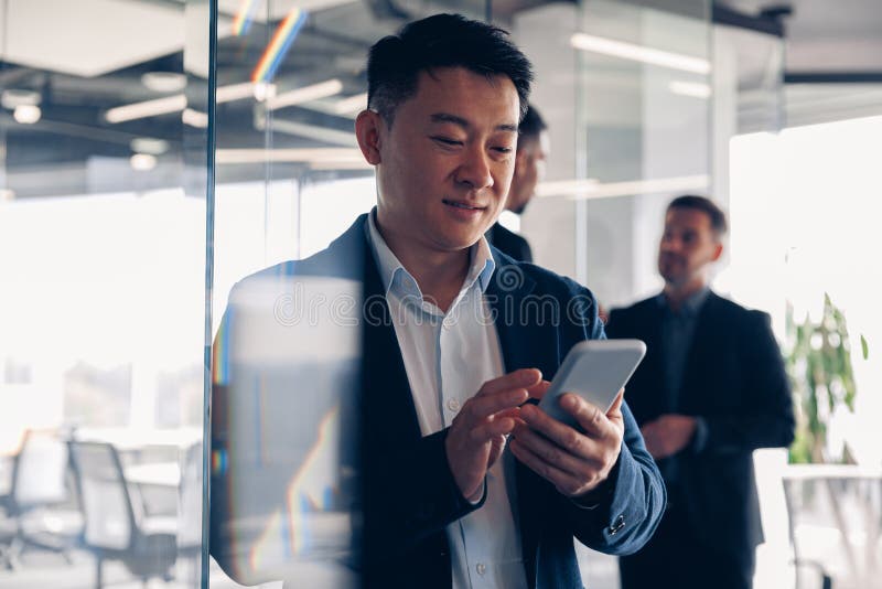 Asian Businessman is Using Phone during Break Time in Modern Office ...