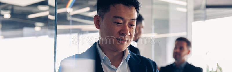 Asian Businessman is Using Phone during Break Time in Modern Office ...