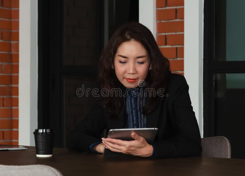 Asian Businesswoman Using Digital Tablet PC in Office, Typing and Looking at Screen Stock Image ...