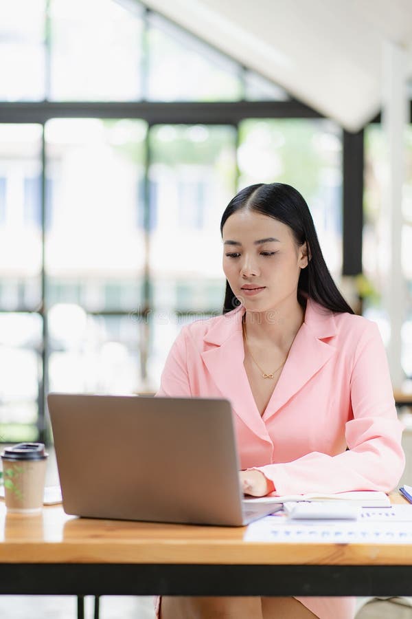 Asian Businesswoman Using Laptop Computer with Documents the Notebook ...