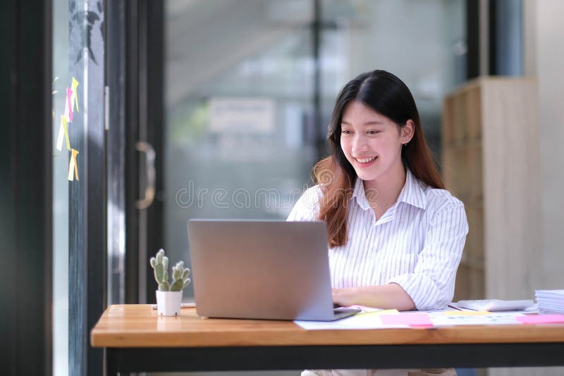 Asian Businesswoman Using Laptop Computer and Working at Office with ...