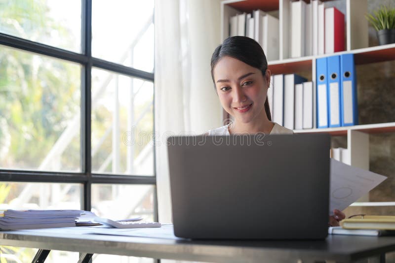 Asian Businesswoman Using Laptop Computer and Working at Office with ...