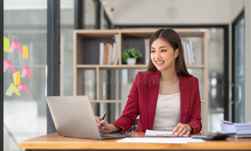 Asian Businesswoman Using Laptop Computer and Working at Office with ...