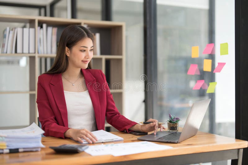 Asian Businesswoman Using Laptop Computer and Working at Office with ...