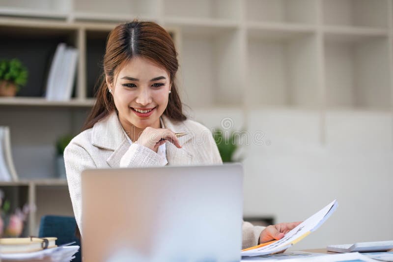 Asian Businesswoman Using Laptop Computer and Working at Office with ...