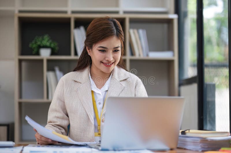 Asian Businesswoman Using Laptop Computer and Working at Office with ...