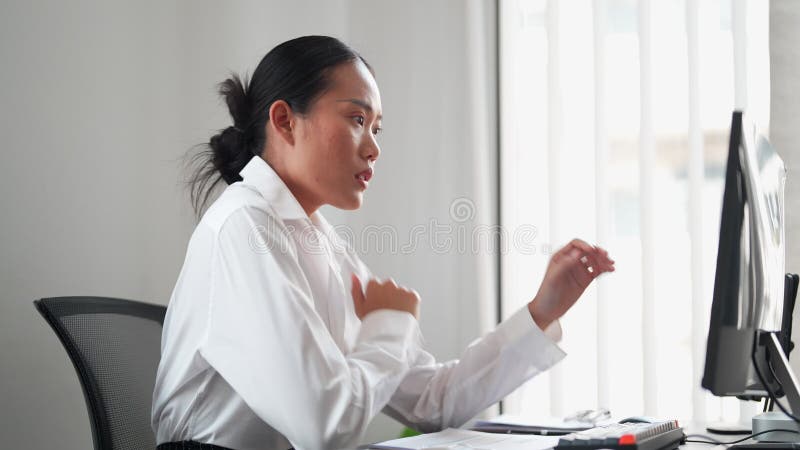 Asian Businesswoman Working on a Computer, Feeling Tired and Frustrated ...