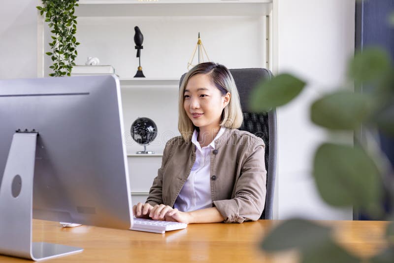 Asian Businesswoman Working in Office Using Computer with Casual Formal ... Asian Businesswoman Working in Office Using Computer with Casual Formal ...
