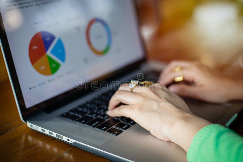 Asian Businesswomen Using Notebook for Analysis Documents and Graph ...