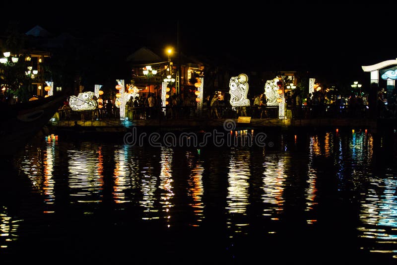 Asian Cafe with Glowing Figures and Lanterns is Reflected in Water at ...
