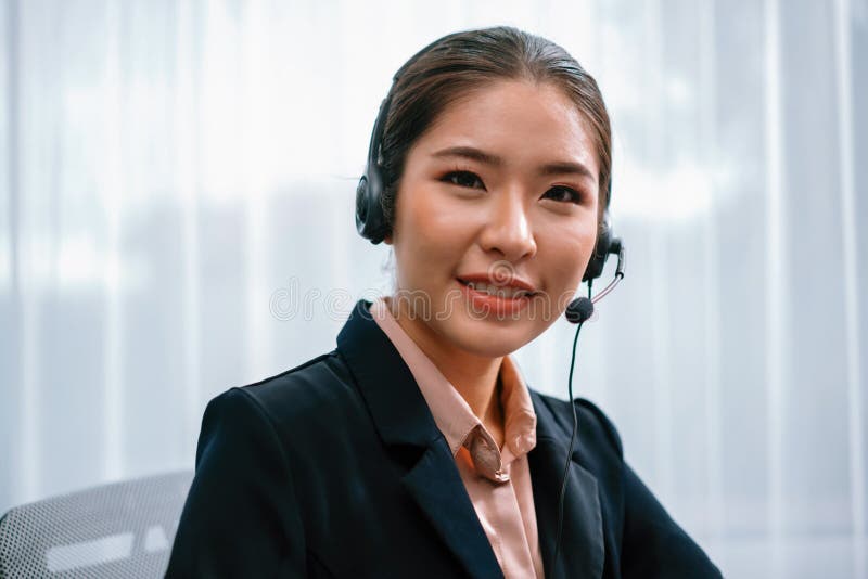Enthusiastic Asian Call Center with Headset and Microphone Working on ...