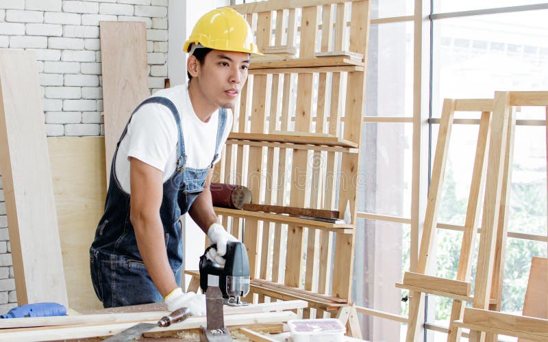 A Carpenter is Making a Hold on Wood by Using a Drill Stock Image ...