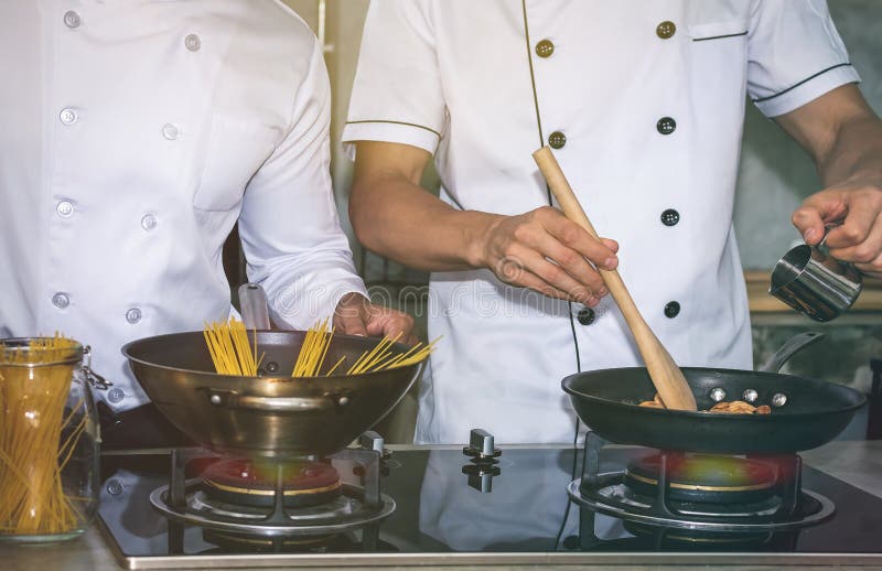 Asian and Caucasian Chefs Together Cook Together Happily. Stock Image ...