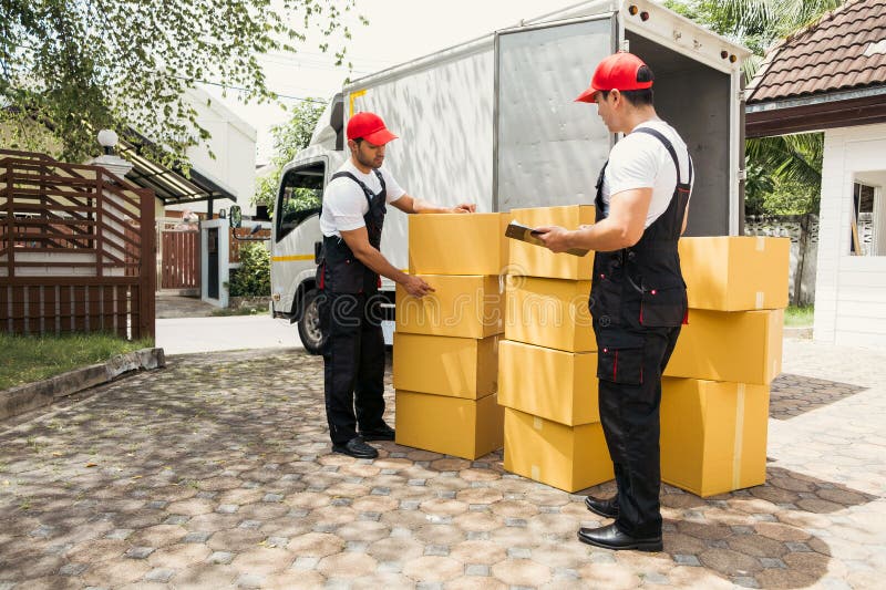 Asian and Caucasian Workers in Uniform Unloading Cardboard Boxes from ...