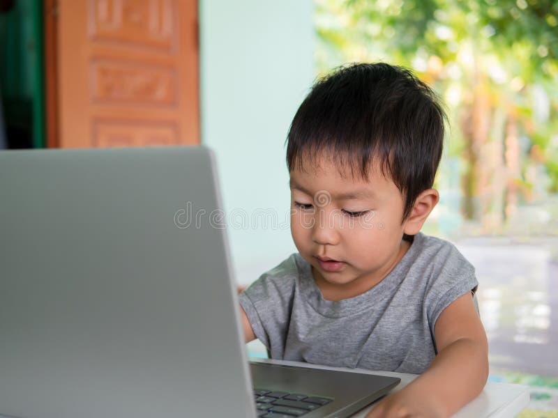 Asian Child Boy Using Notebook or Laptop in Rural at Home. Stock Photo ...