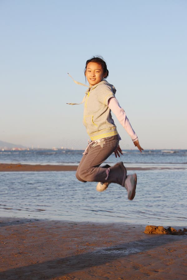 Asian Child Jumping on Beach Stock Photo - Image of smile, outdoor ...