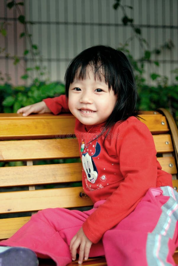 Asian Child Smile On The Stool Stock Photo - Image of body, arms: 8923916